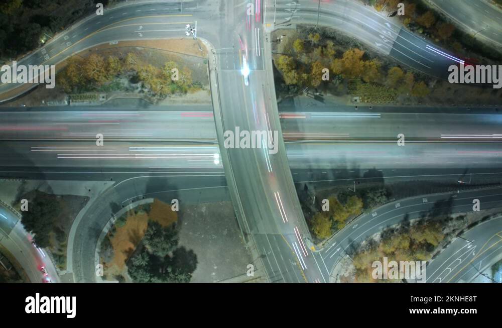 Cinematic top view time-lapse of car traffic at busy highway ramps with ...
