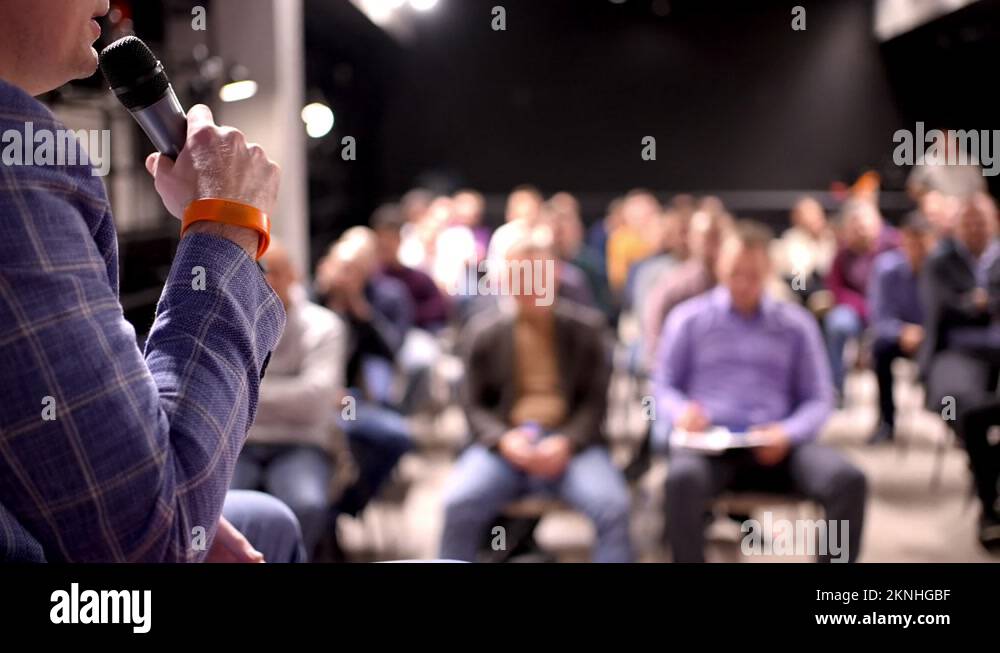 People audience at hall. Speaker man seminar public on stage speaking ...