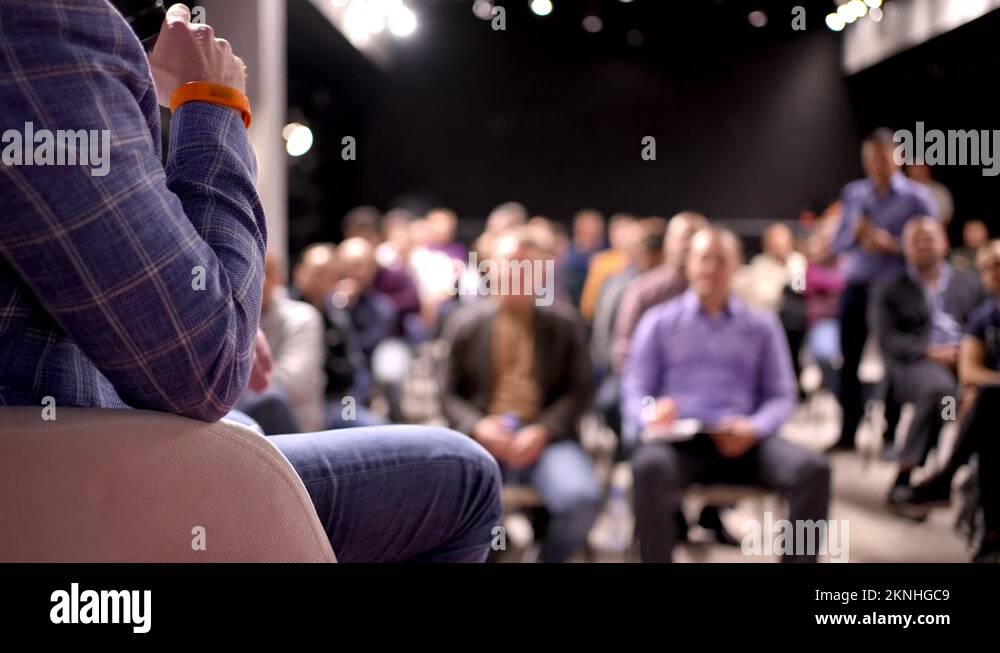 People audience at hall. Speaker man seminar public on stage speaking ...