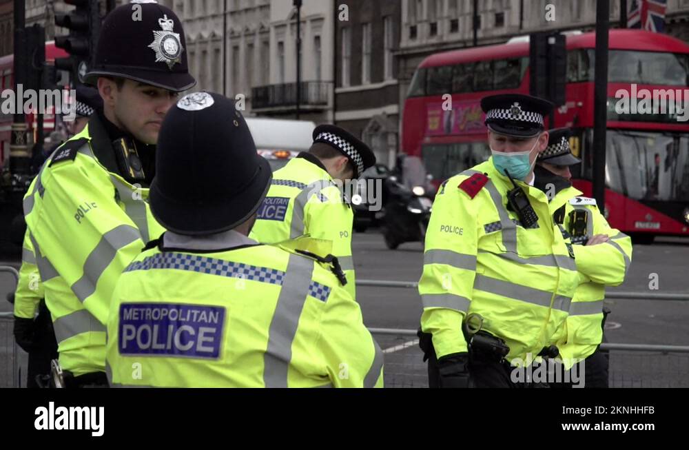 London Metropolitan police officers stand talking to each other on ...