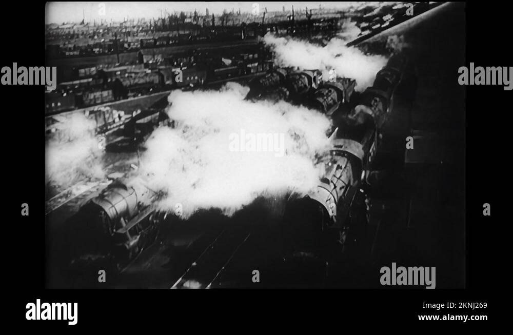1940s: Trains. Railyard. Engineer leans out window. Fleet of docked ...