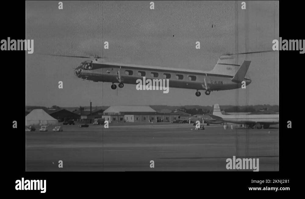 1950s: Shots of helicopter flying. Crowd sitting on grass. Jet flying ...