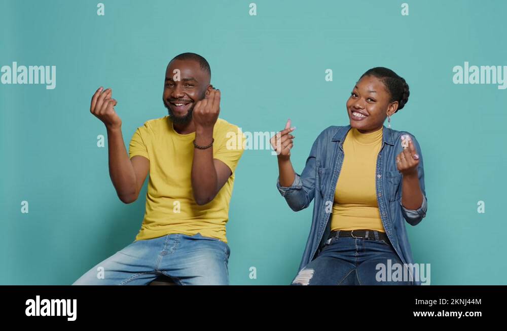 People using body language to do money gesture with hands in studio ...