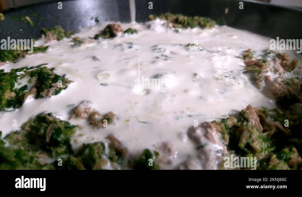 Adding cream while cooking fish Stock Video Footage - Alamy