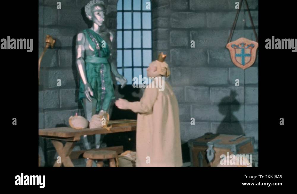 1940s: Castle vault. Puppet king and silver statue speak. Hand holds ...