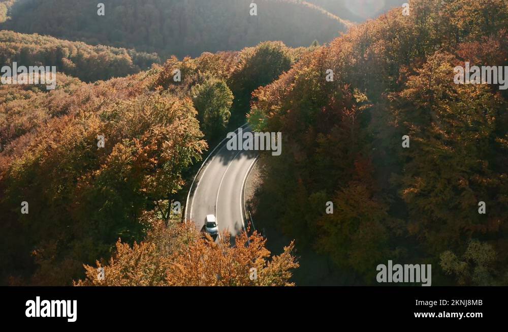 Beautiful aerial overhead footage of cars driving on a scenic road winding Stock Video Footage ...