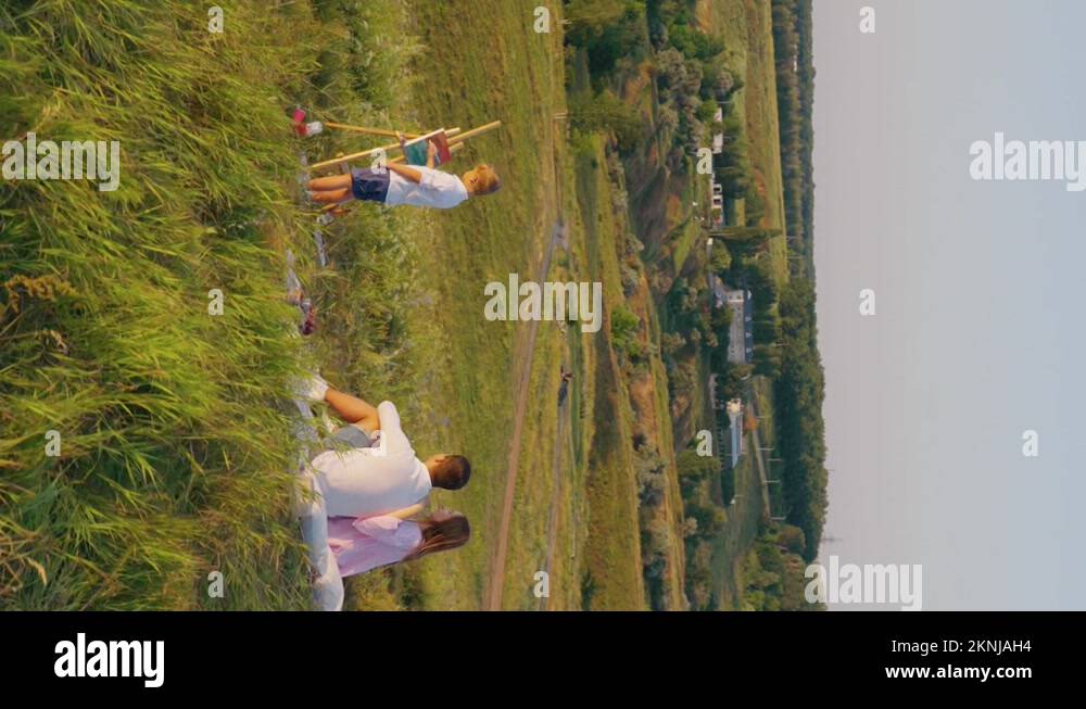 Vertical Screen: Boy painting in open air and parents watching Stock ...