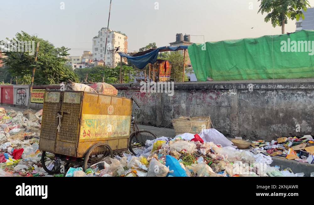 piles of garbage and waste thrown in open air on city street beside ...