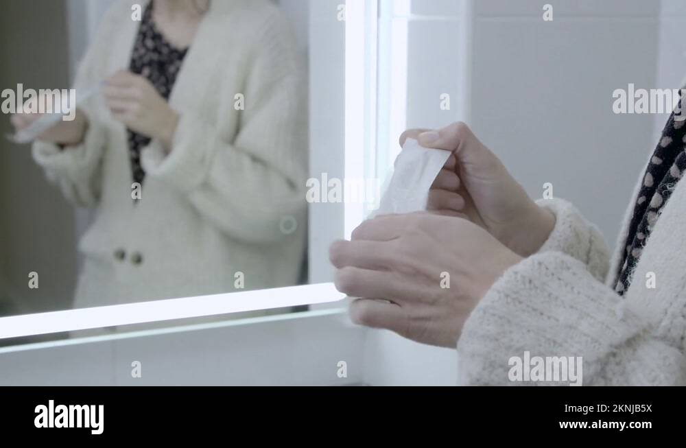 Female unpacking nose stick for Covid 19 test in domestic area, close ...