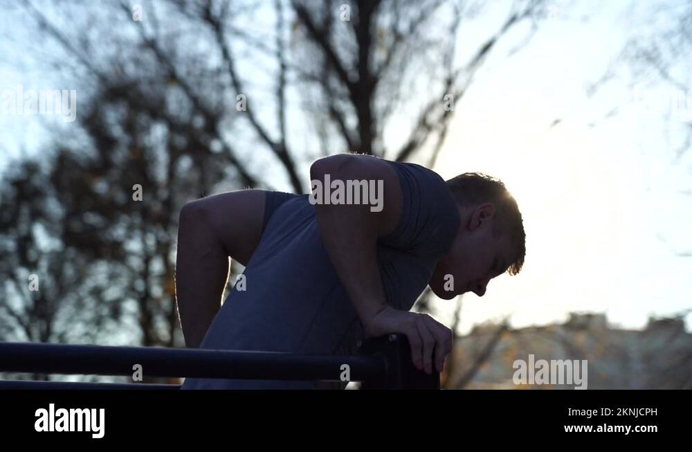 Muscular man doing on sunset sky background. Calisthenics, healthy ...