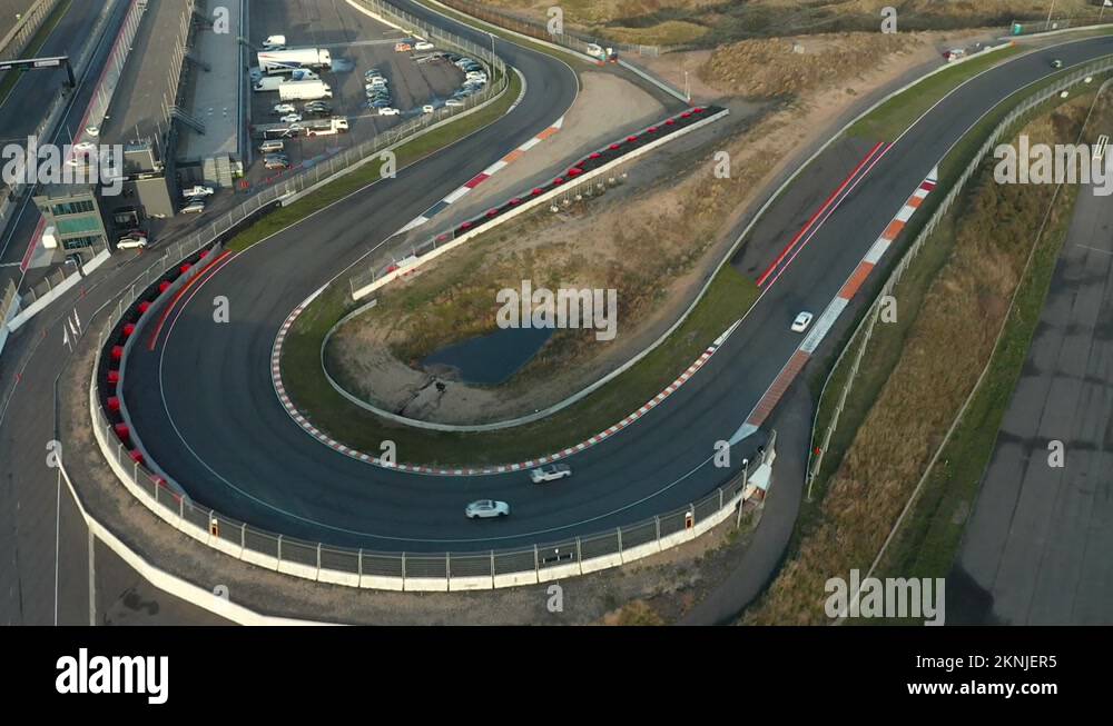 F1 Racing Cars Moving On A Sharp Turn On The Circuit Of Zandvoort, The ...