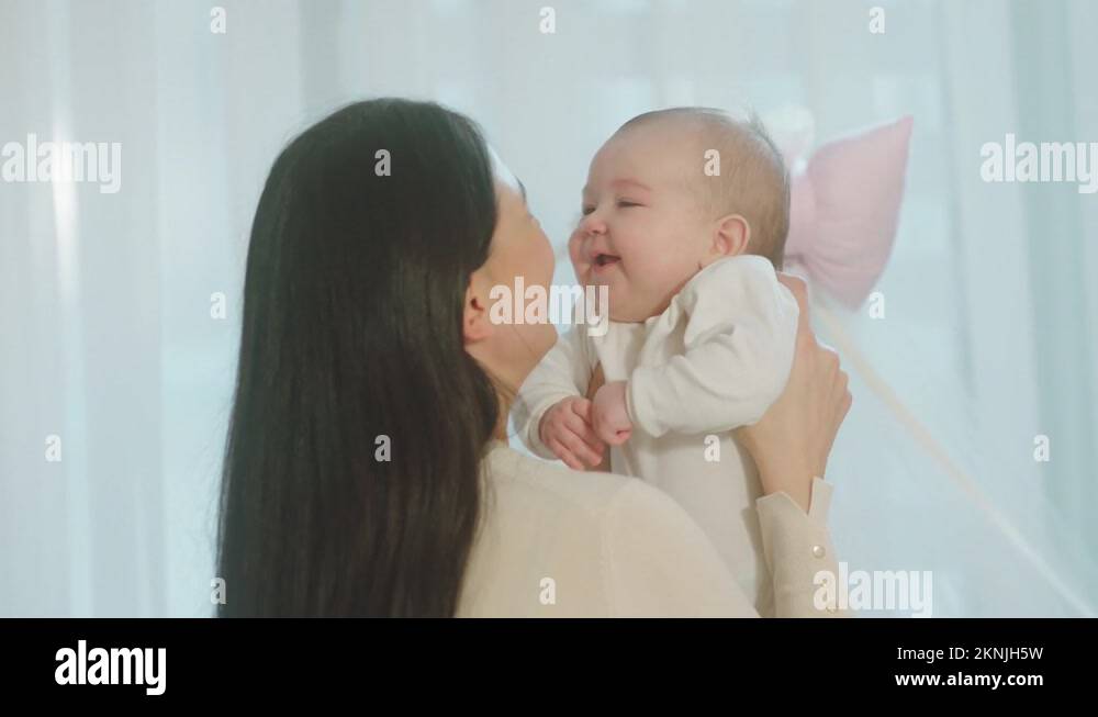 Cute baby girl and her young mother together discussing mother happy enjoy the Stock Video ...