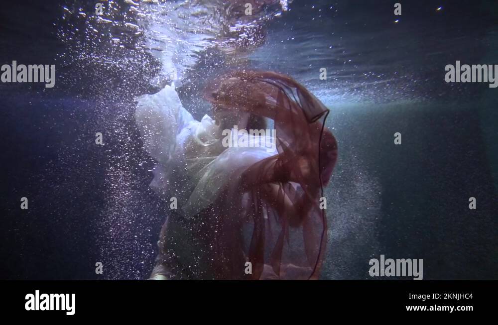 female figure underwater, silhouette of slender lady in air bubbles in ...
