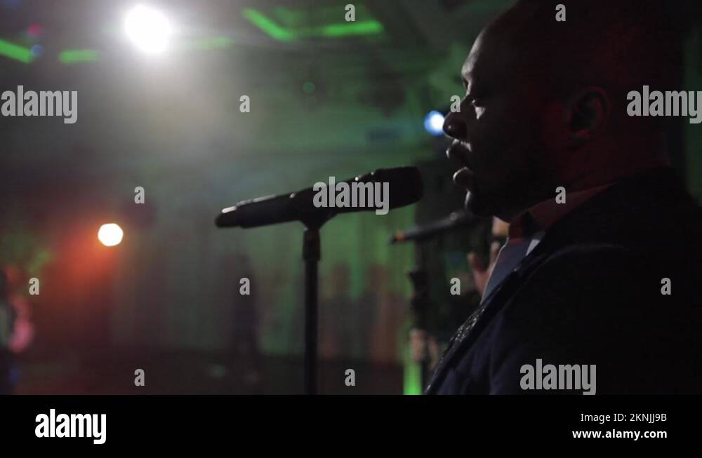 African American soloist on stage singing into microphone Stock Video ...