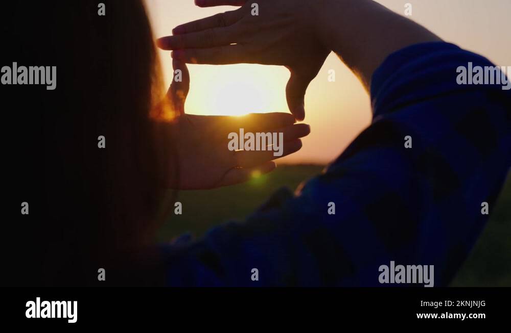 Hands of a young female director cameraman making a frame gesture at ...
