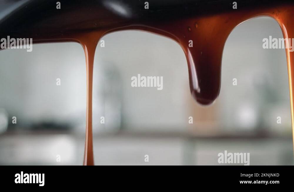 Seamless dripping melted liquid chocolate sweet sauce in kitchen ...