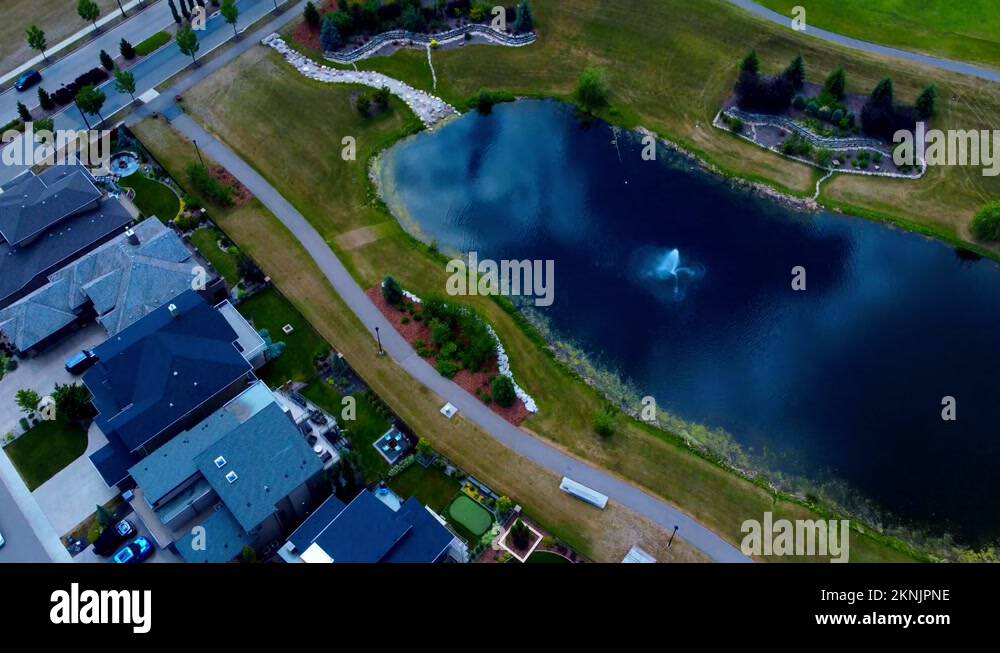 Summer aerial flyover birds eye mansion next to golf club with ...