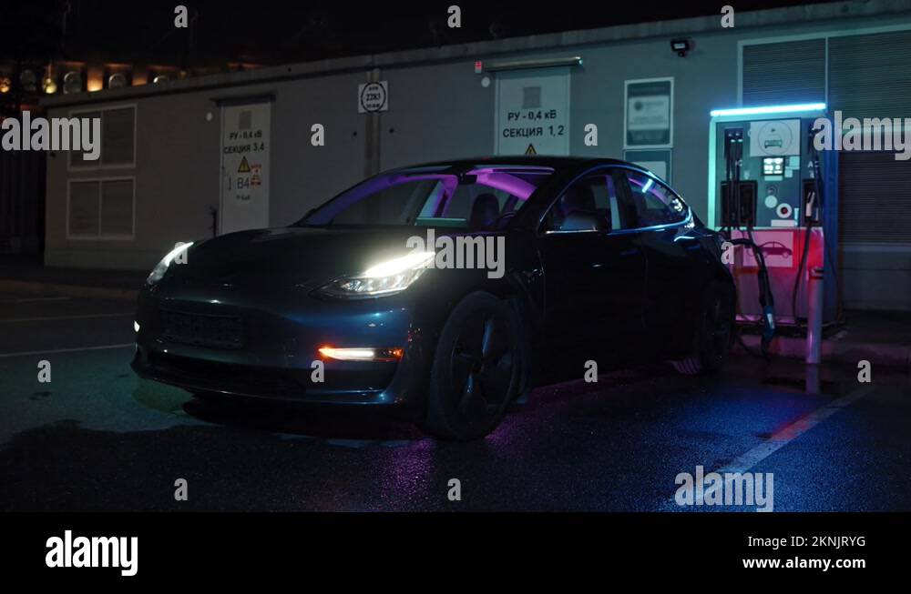 Charging Electric Car at EV Station at Night Stock Video Footage - Alamy