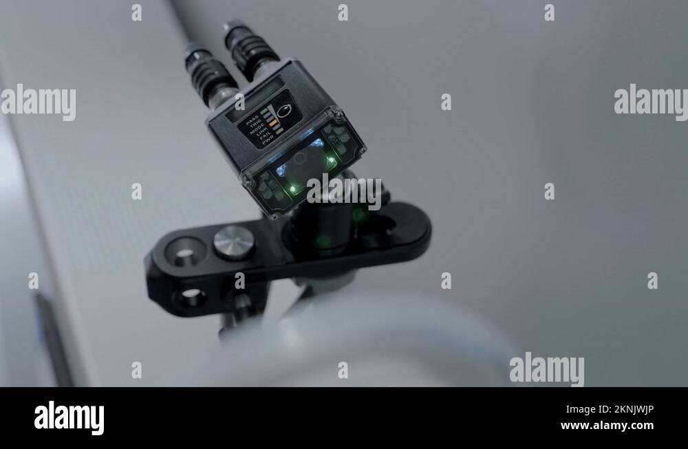 An industrial laser sensor on a conveyor detects the passage of a ...