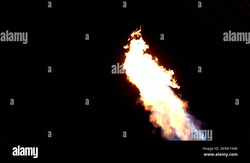 Stream of fire burning in the darkness inside of hot air balloon filmed ...