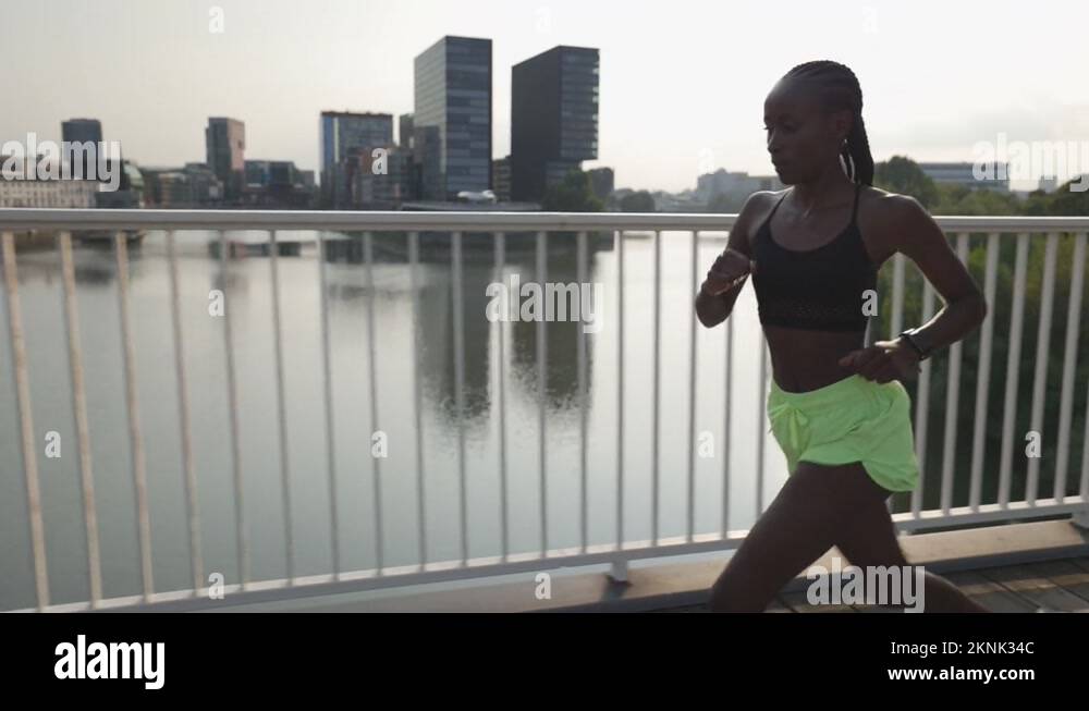 African american woman in activewear running fast on bridge Stock Video ...