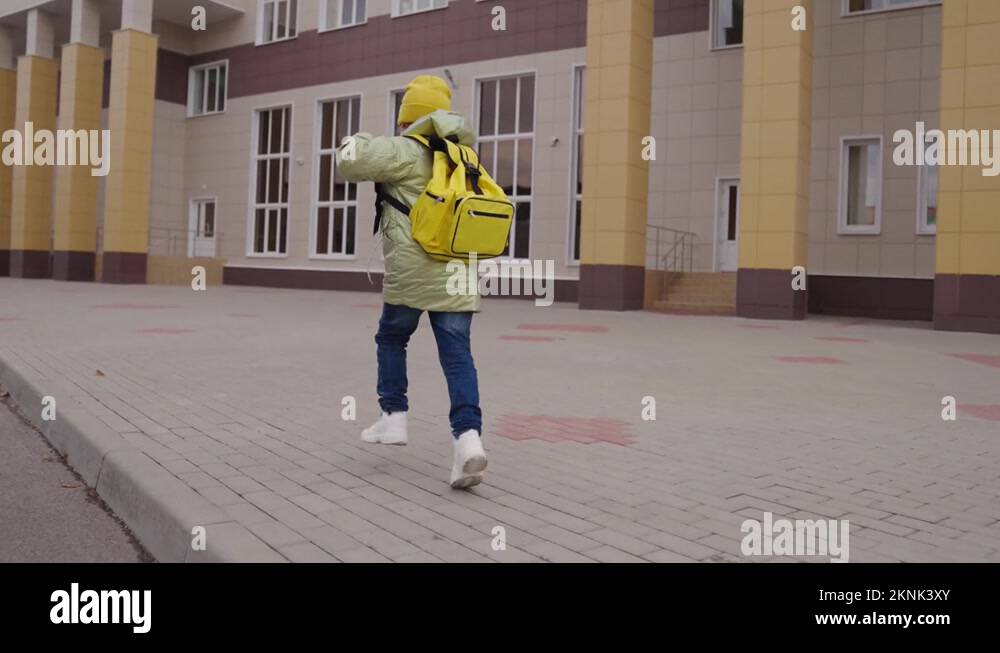 little girl run through the schoolyard to class, child rushing school ...