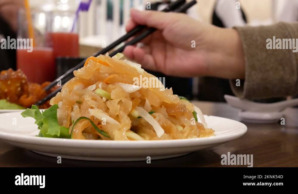 The motion of people eating appetizers on a table inside a Chinese ...