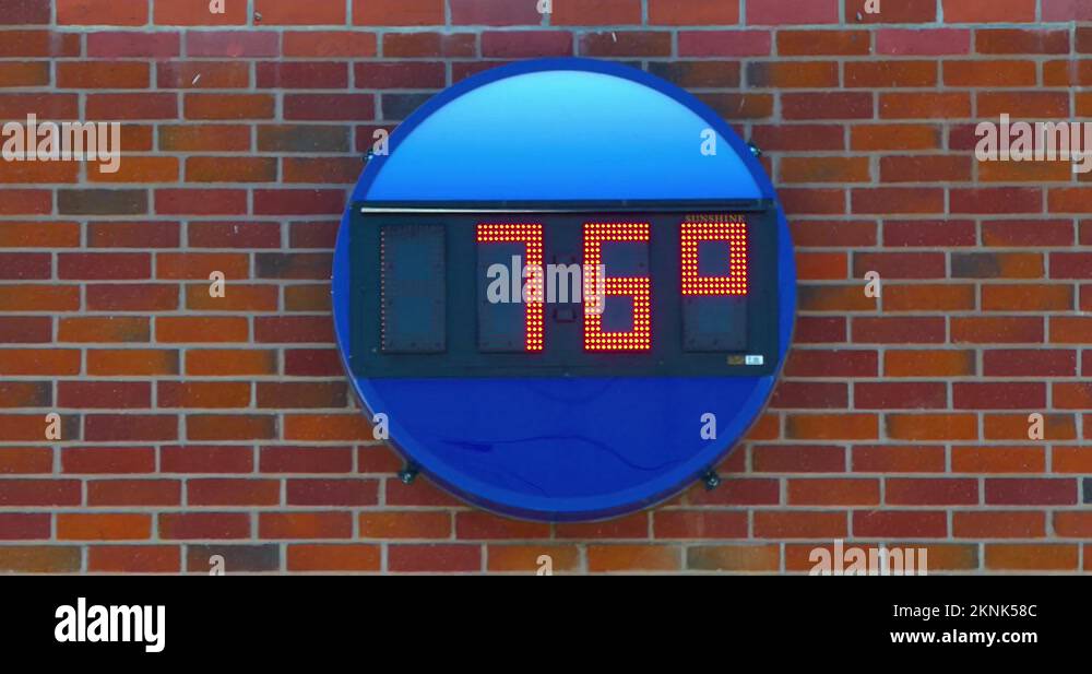 Outdoor digital LED clock and thermometer displaying time and ...