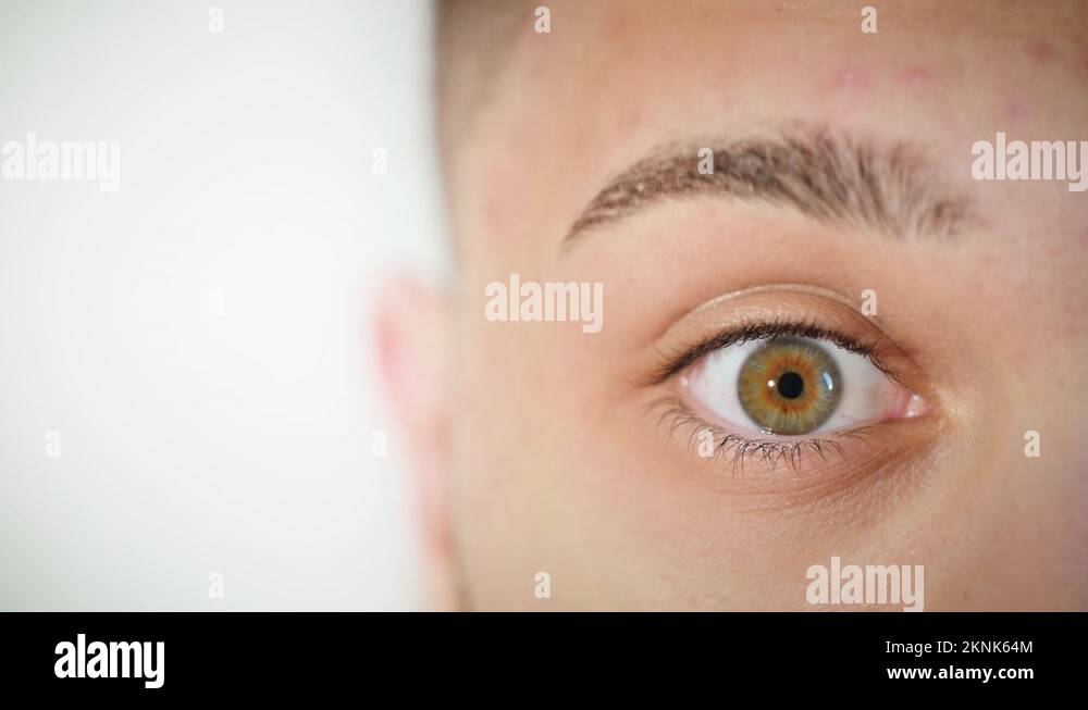 Macro close up of surprised or shocked man's face with beautiful hazel ...