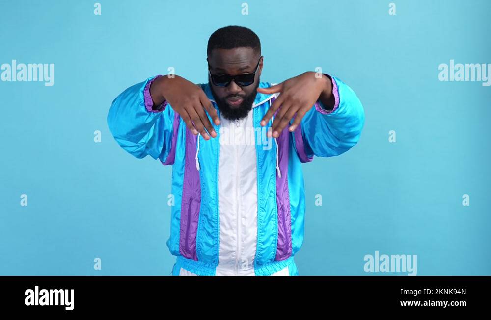 Annoyed angry man bodyguard show stop sign isolated blue color ...