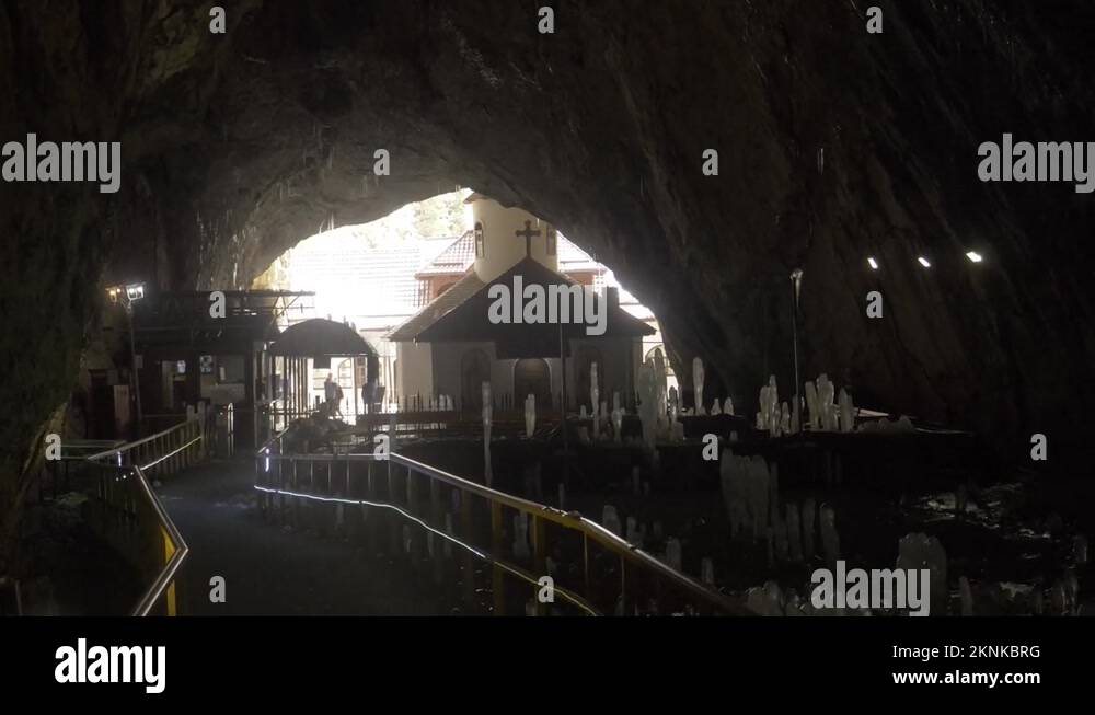 Pavement leading to a church inside a dark cave filled with ice. wide ...