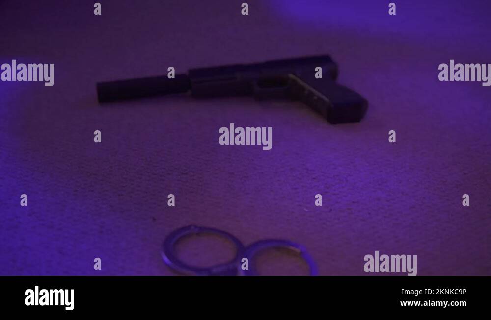 Crime scene various evidences of a murder. Handcuffs, gun and phone 911 ...