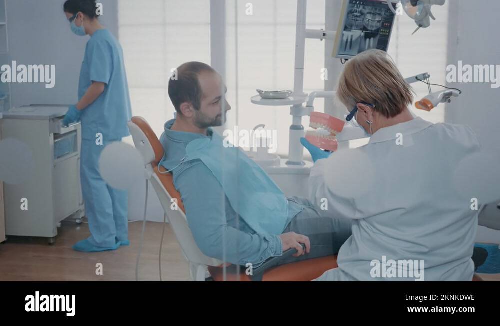 Dentist giving hygiene lesson to patient to clean teeth correctly Stock ...