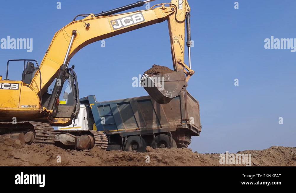 An Excavator cutting soil moorum and loading in a dump truck - Dump ...