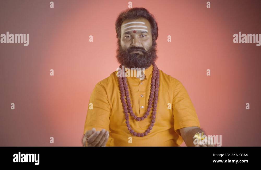 indian saadhu or holy god man praying god and chanting mantras or hymns ...