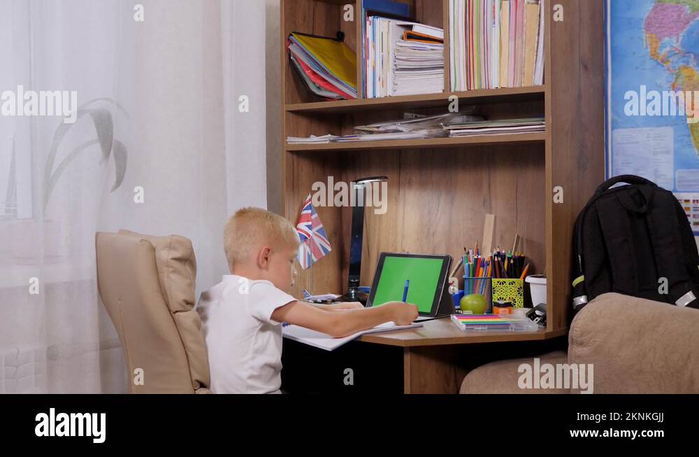 Preschool child boy distance online learning at home. Green screen ...