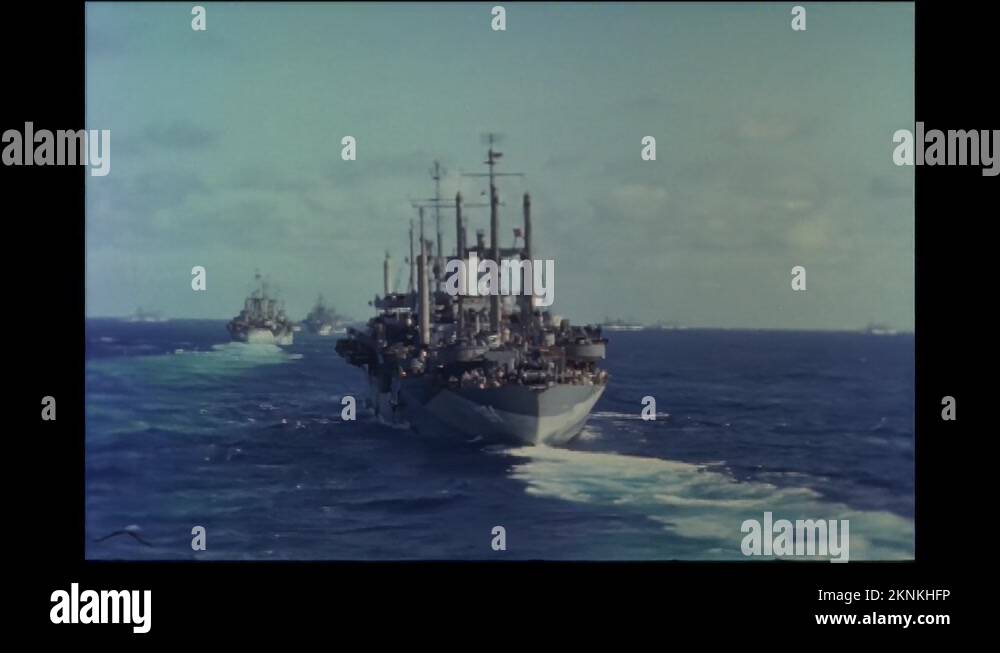 1940s: Naval ships move in a convoy. Black clouds of flak dot the sky ...