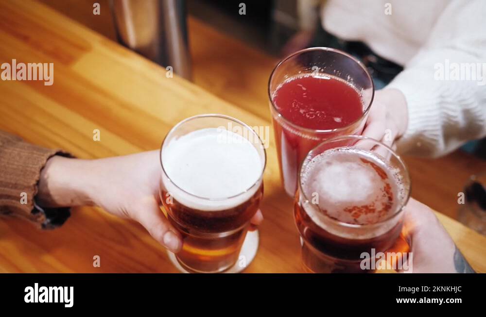 Toasting with foamy beer in glasses top view. Celebrating and drinking ...