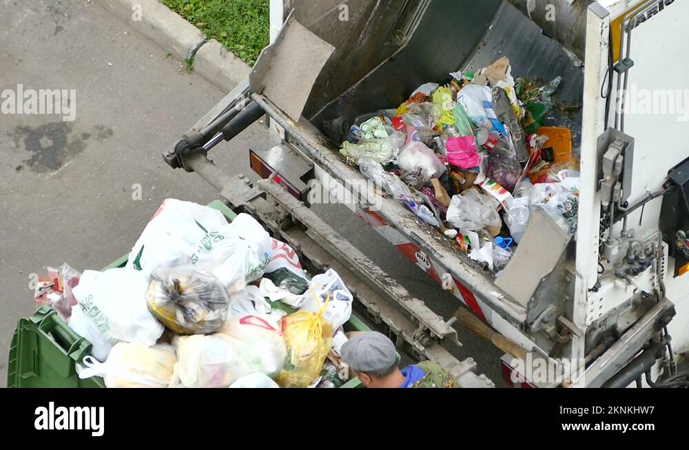 Garbage men collect mixed household waste in residential area, Moscow ...