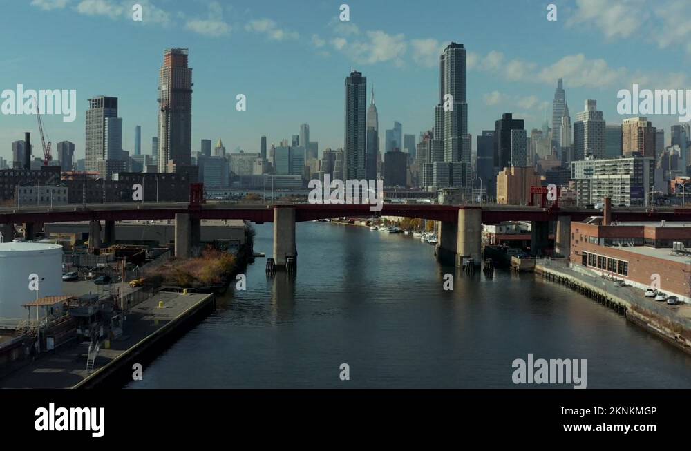 Forwards fly above water channel in industrial borough. Modern high ...