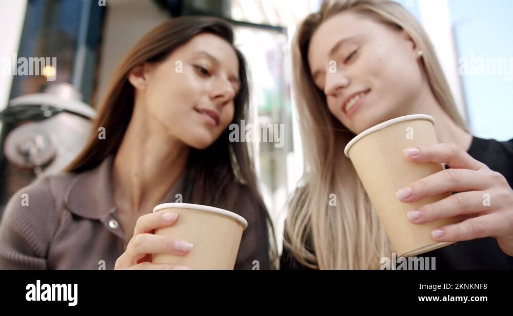 Close Up, two beautiful girls cheers tea drinks with paper cup on ...