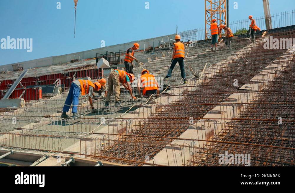 Working process at a construction site. Workers make a reinforced ...