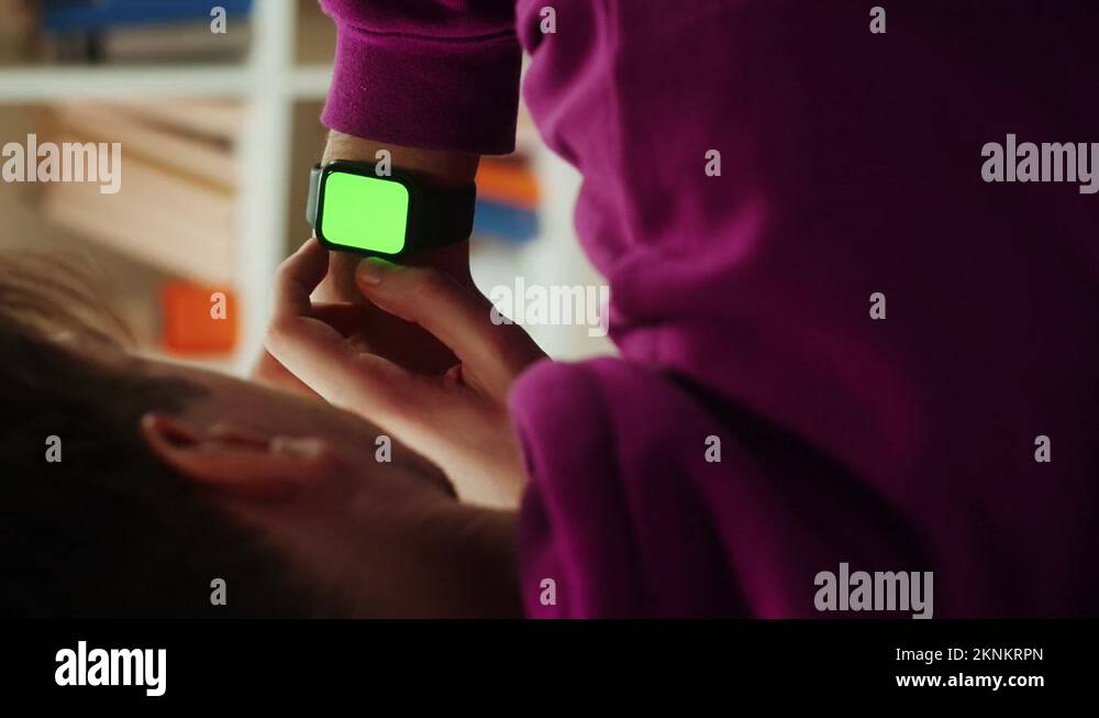 Vertical video of man using smartwatch with chroma key close-up. Young ...