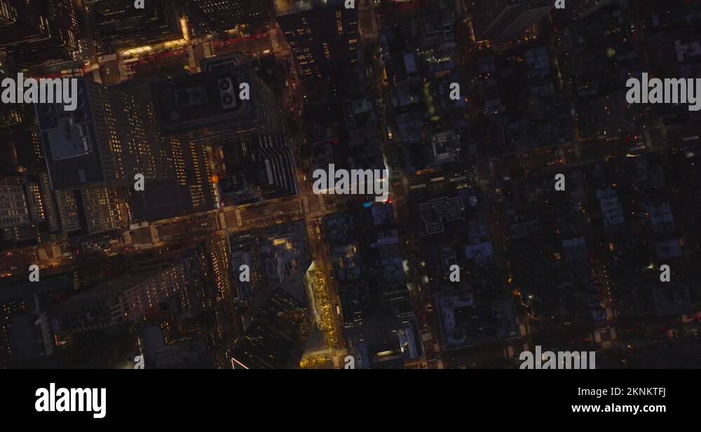 Aerial birds eye overhead top down view of illuminated streets in ...