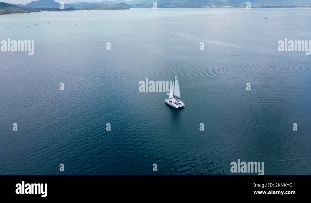Sailing catamaran with open sails in the clear sea Stock Video Footage ...