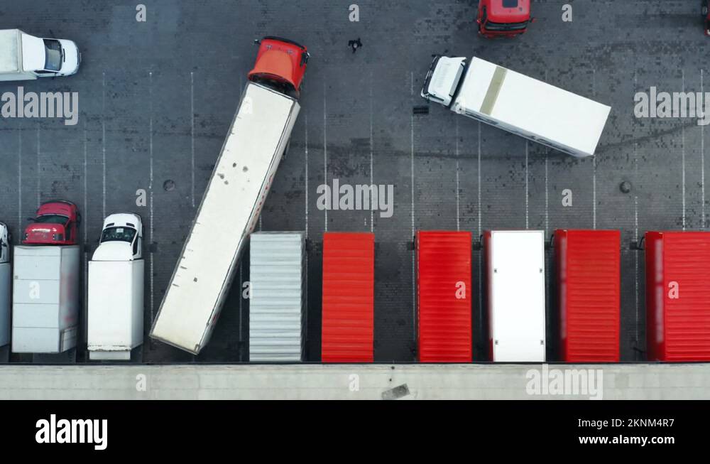 Semi-trailer truck maneuvers at a logistics warehouse. Cargo containers ...