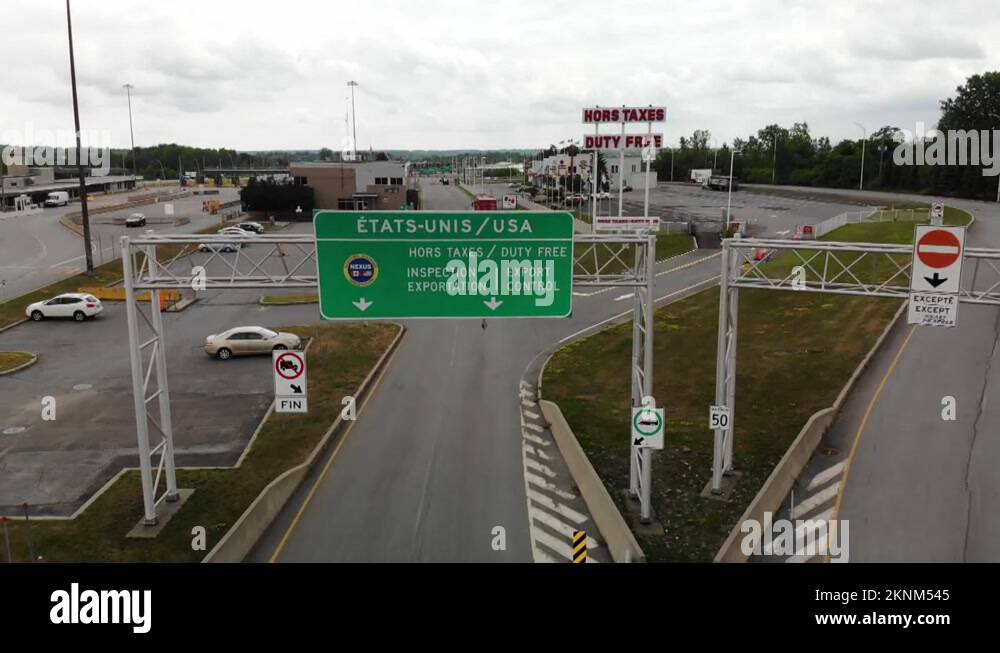 Drone pushes out and lifts above signage for USA border at Lacolle ...