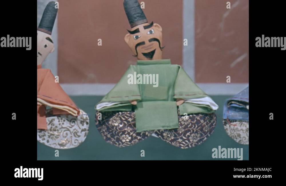 1960s: Animation. Three men in kimonos sit cross-legged together. Man ...