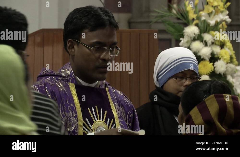 Indian Christian crowded mass church, devotees taking the Holy Host ...
