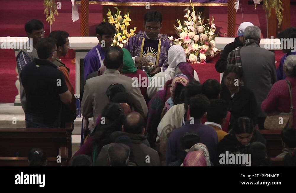 Indian Christian crowded mass church, devotees taking the Holy Host ...